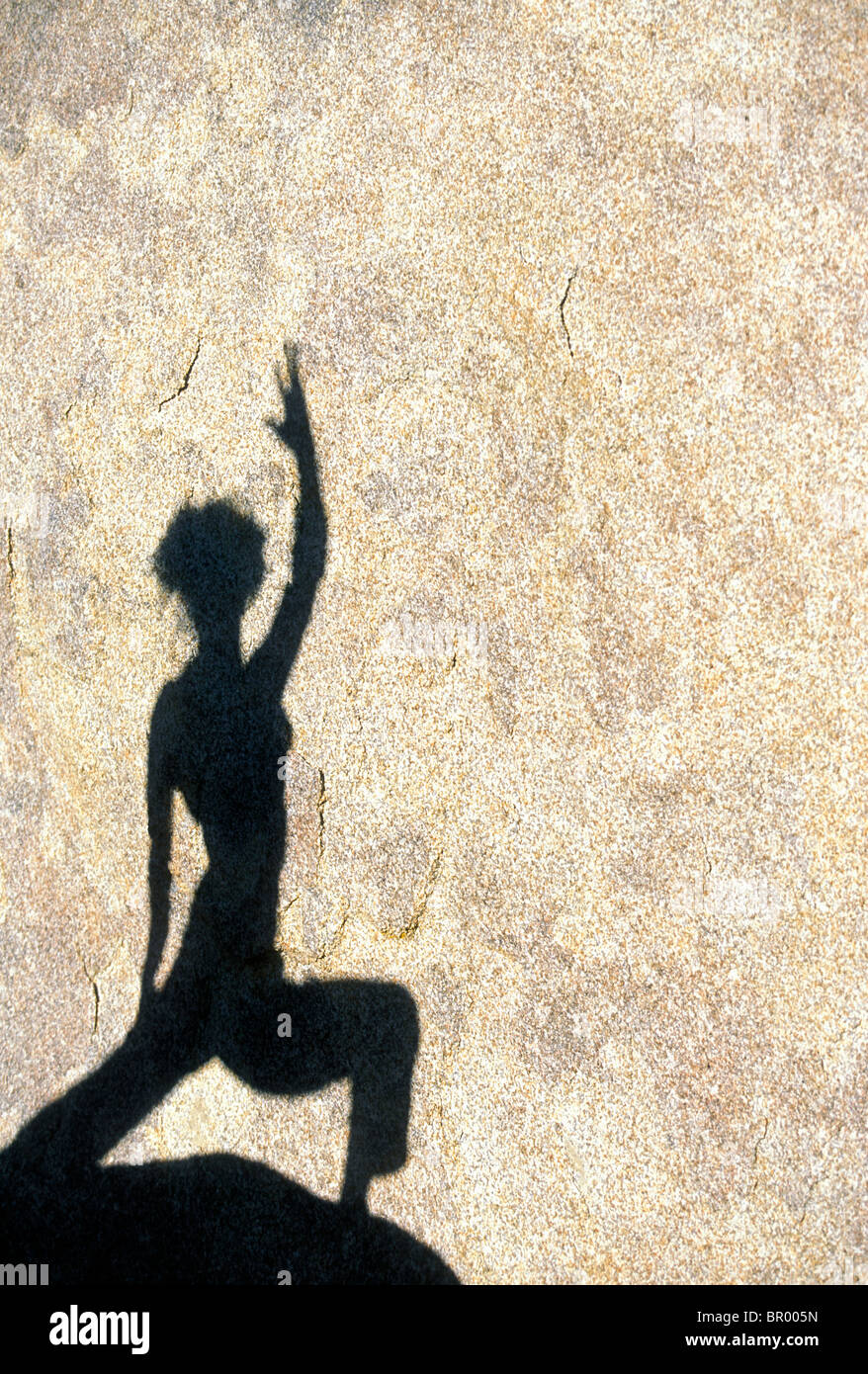 Woman with shadow displaying stength,balance, and focus in yoga pose on ...