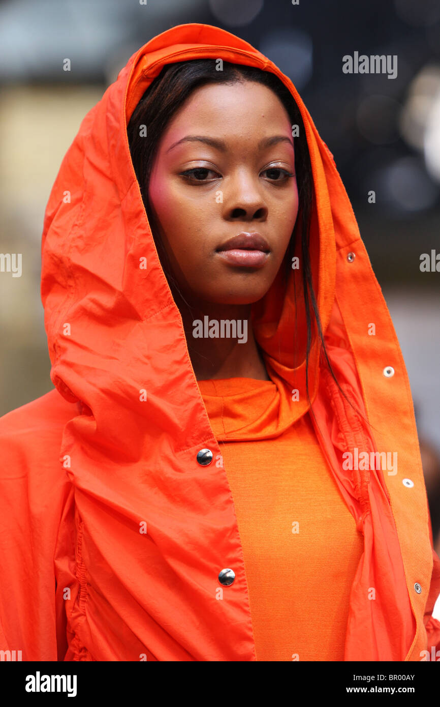 Black model with orange cloth during a fashion show during the ...