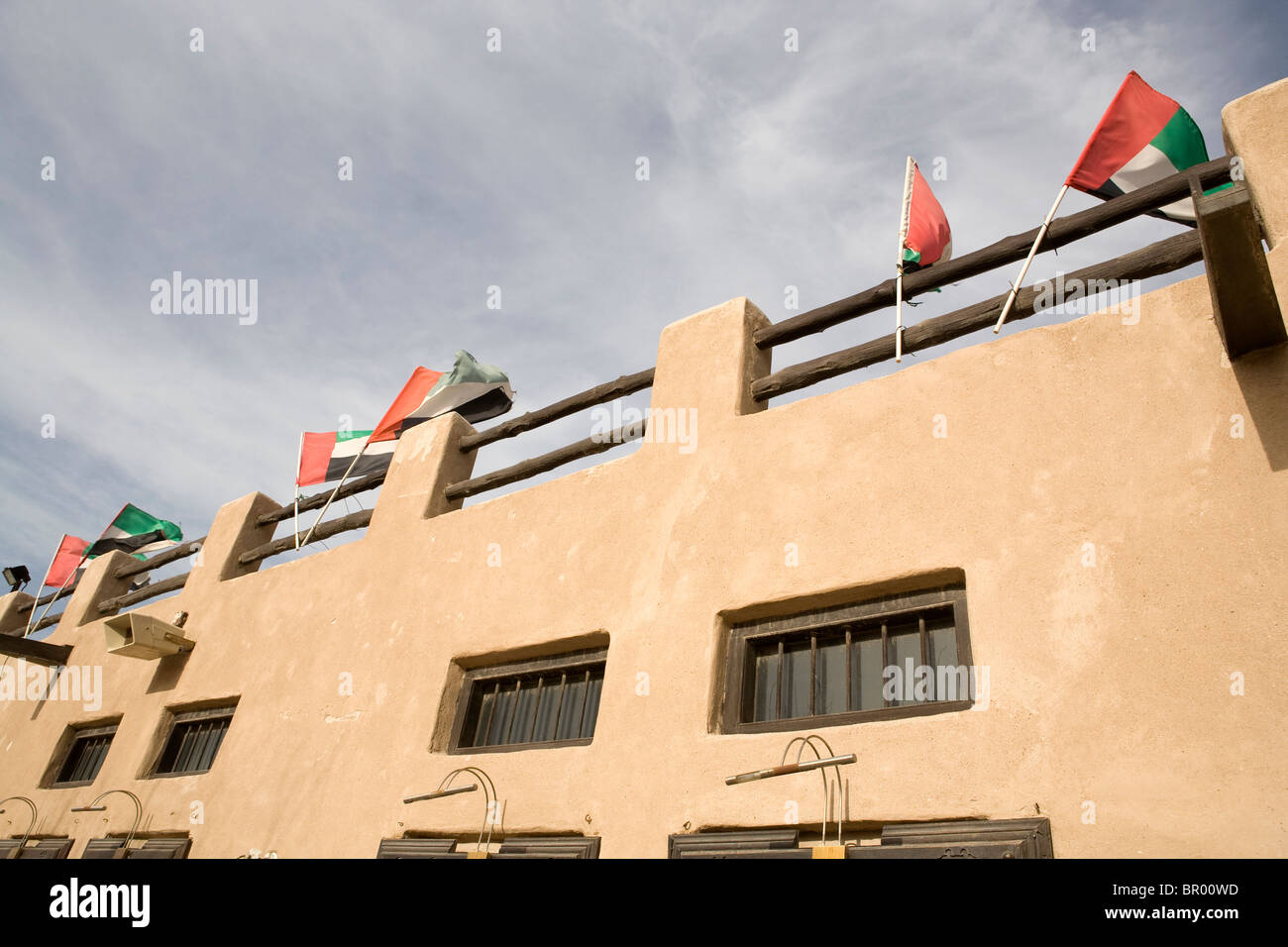 Heritage building with Emirates flags on top in Dubai Stock Photo - Alamy