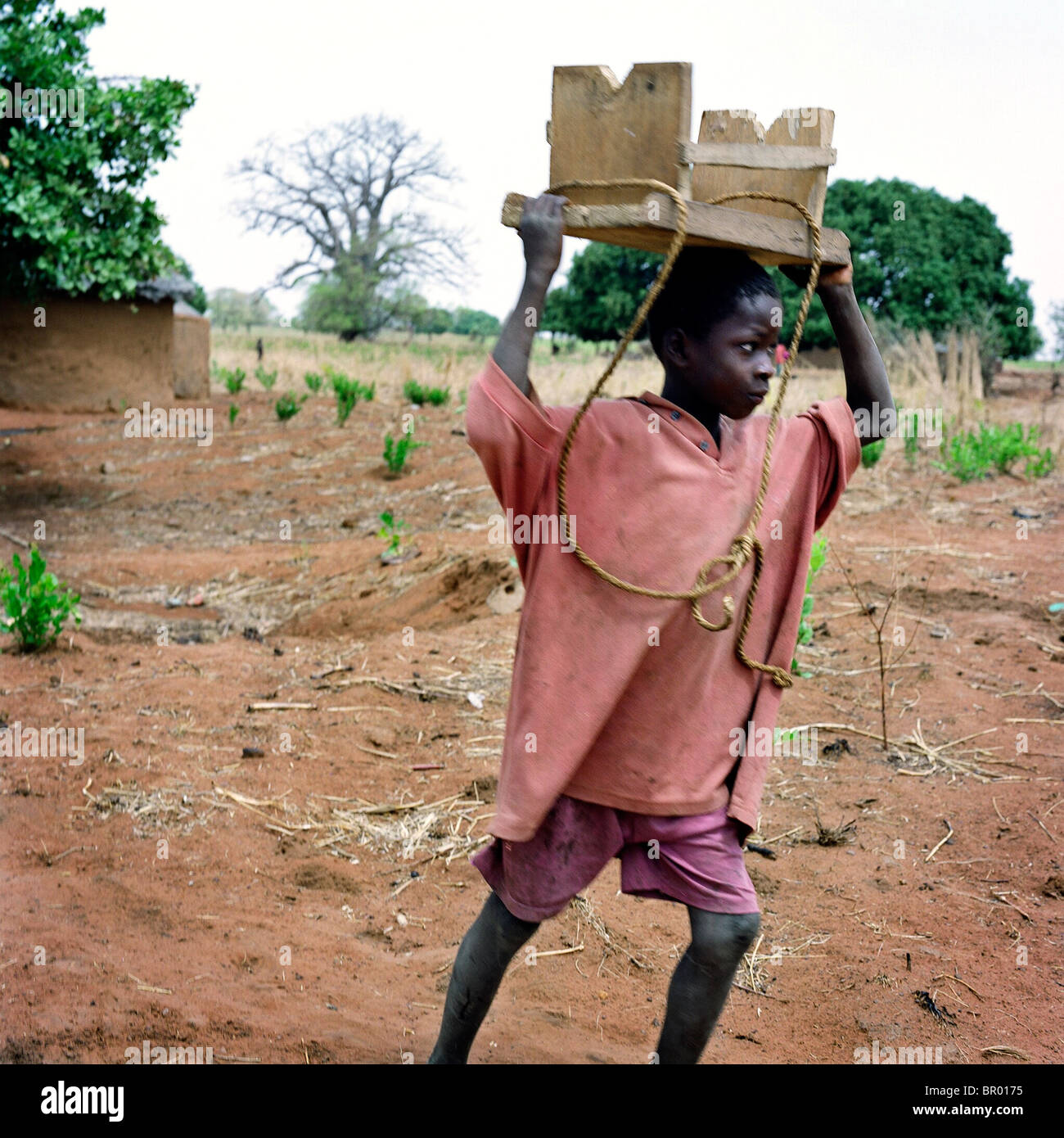 A youg boy carring a chair Stock Photo - Alamy