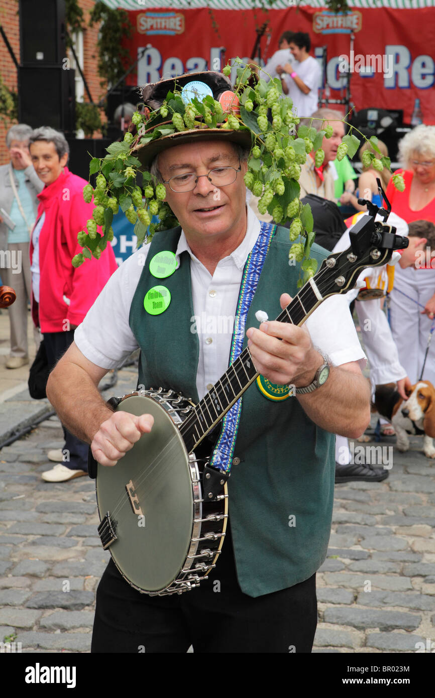 A man playing an instrument in the street at the Faversham hop festival ...