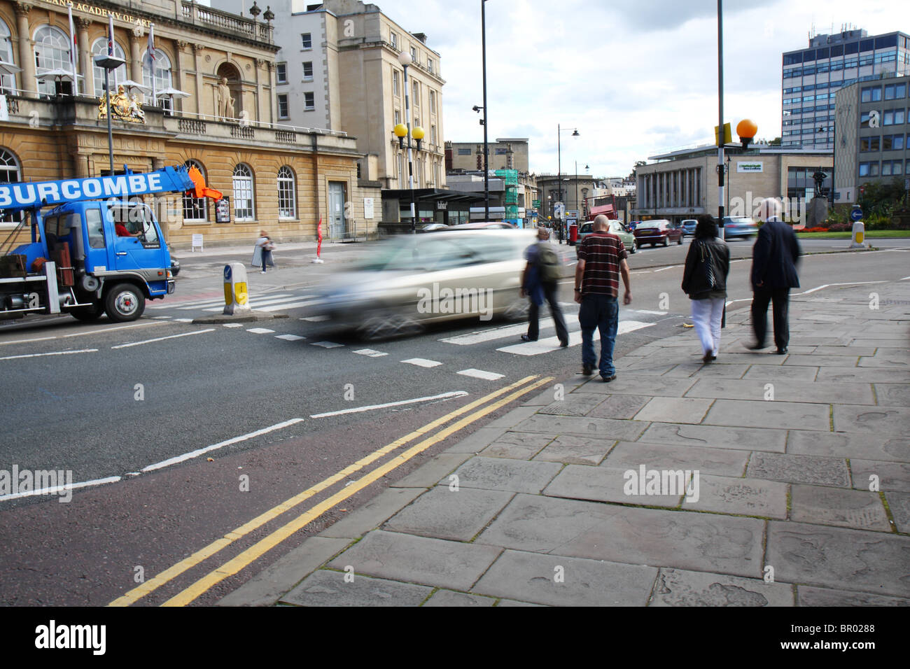 Pedestrian crossing the road using a zebra crossing Stock Photo - Alamy