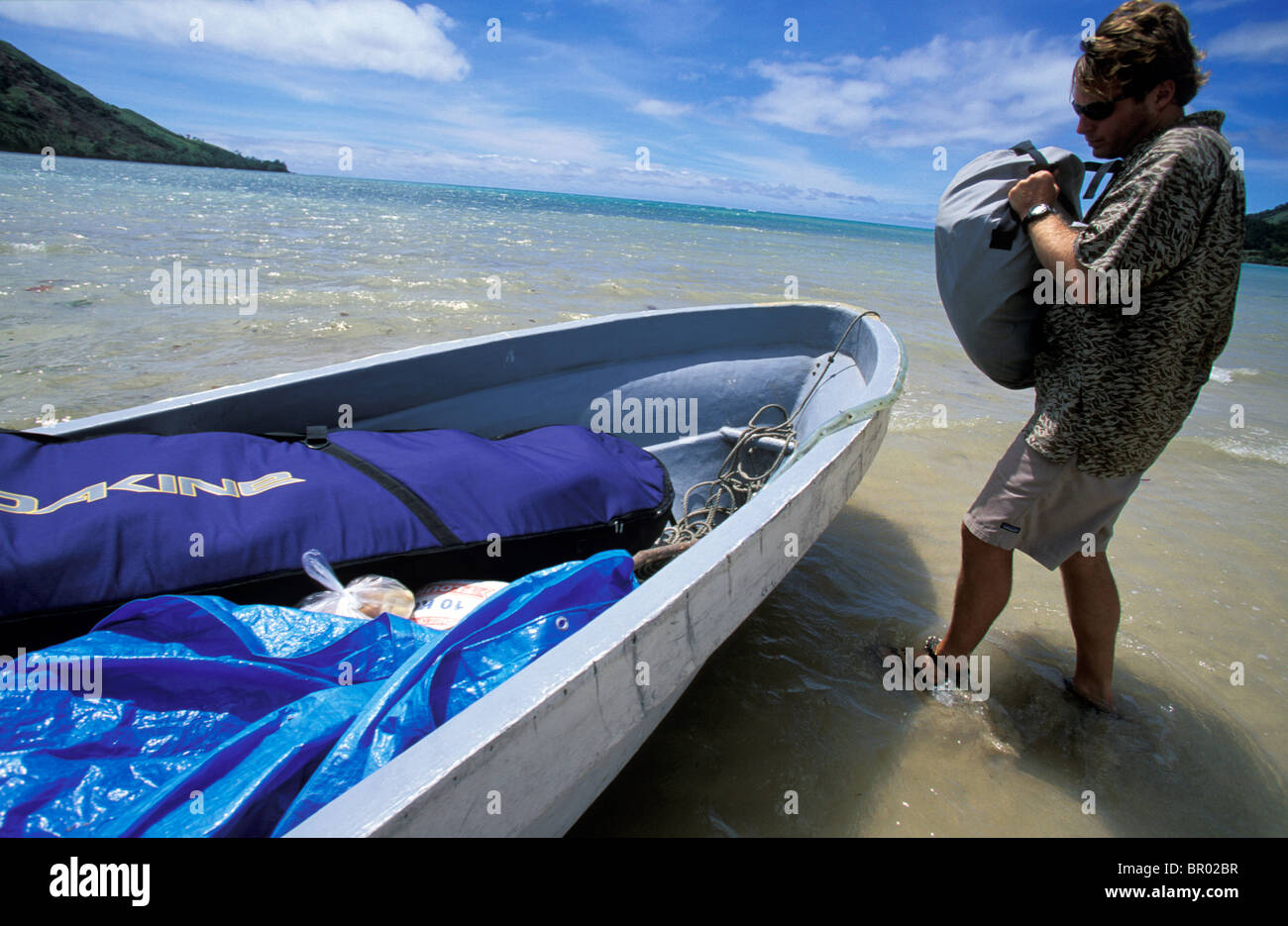 A man loading his gear into a boat Stock Photo - Alamy