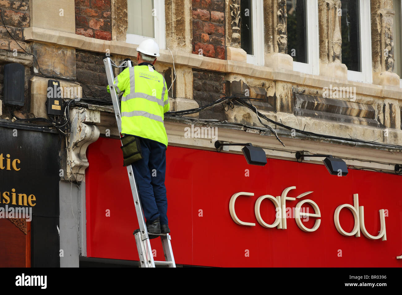 Workman on ladder Stock Photo - Alamy