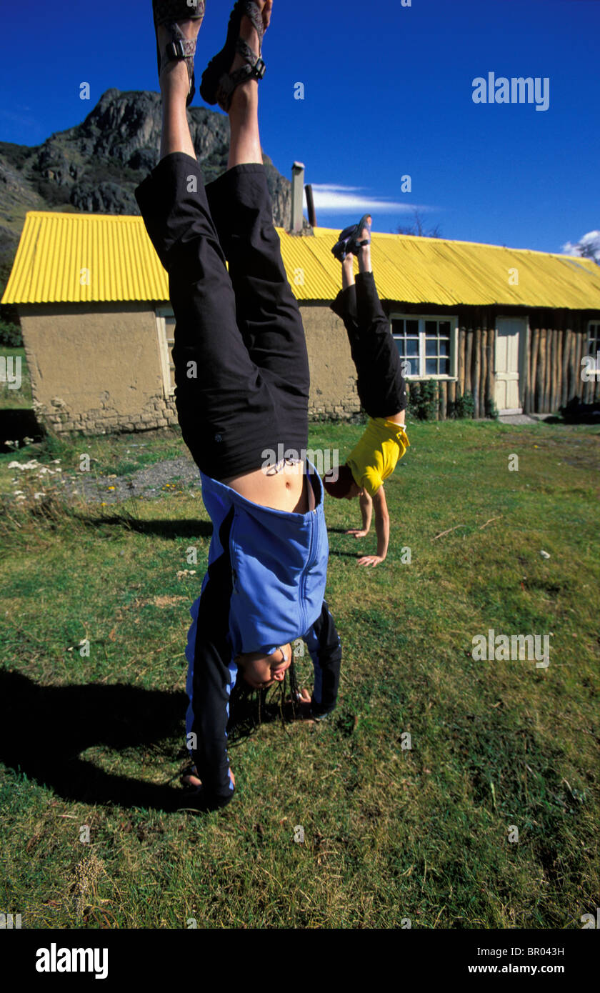 Two people doing handstands in the grass Stock Photo - Alamy