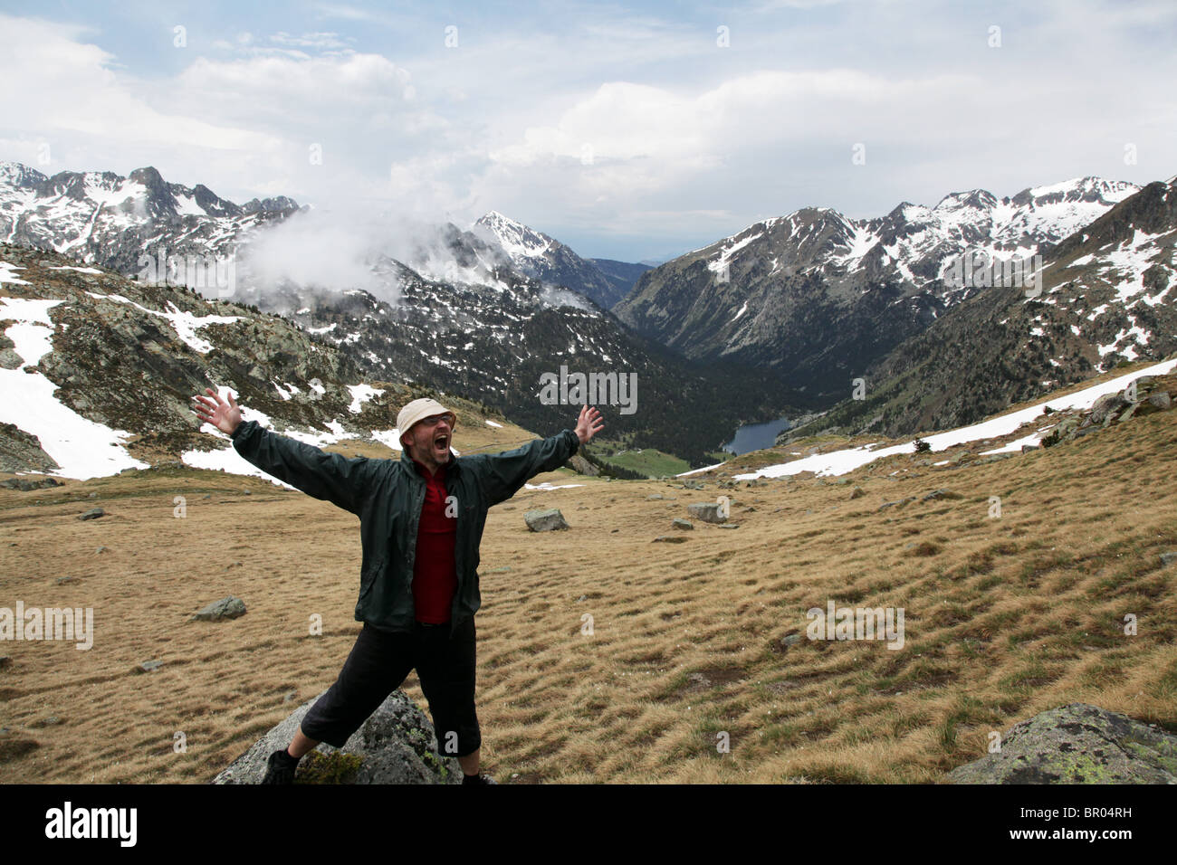 Crazy climber screaming at Estany Llong view from top of Portarro d ...