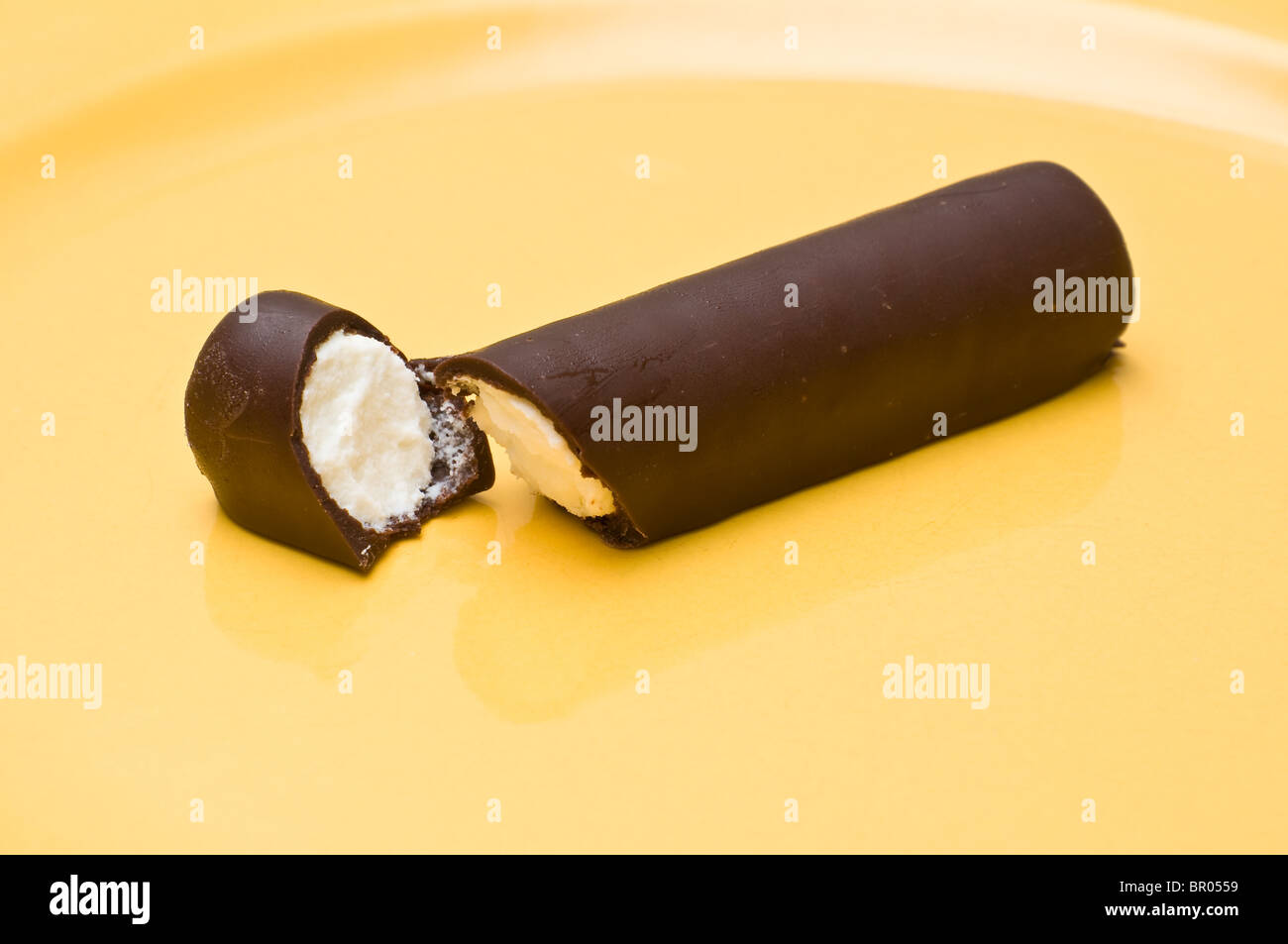 Broken cheese rod of Hungary resting on yellow plate Stock Photo - Alamy