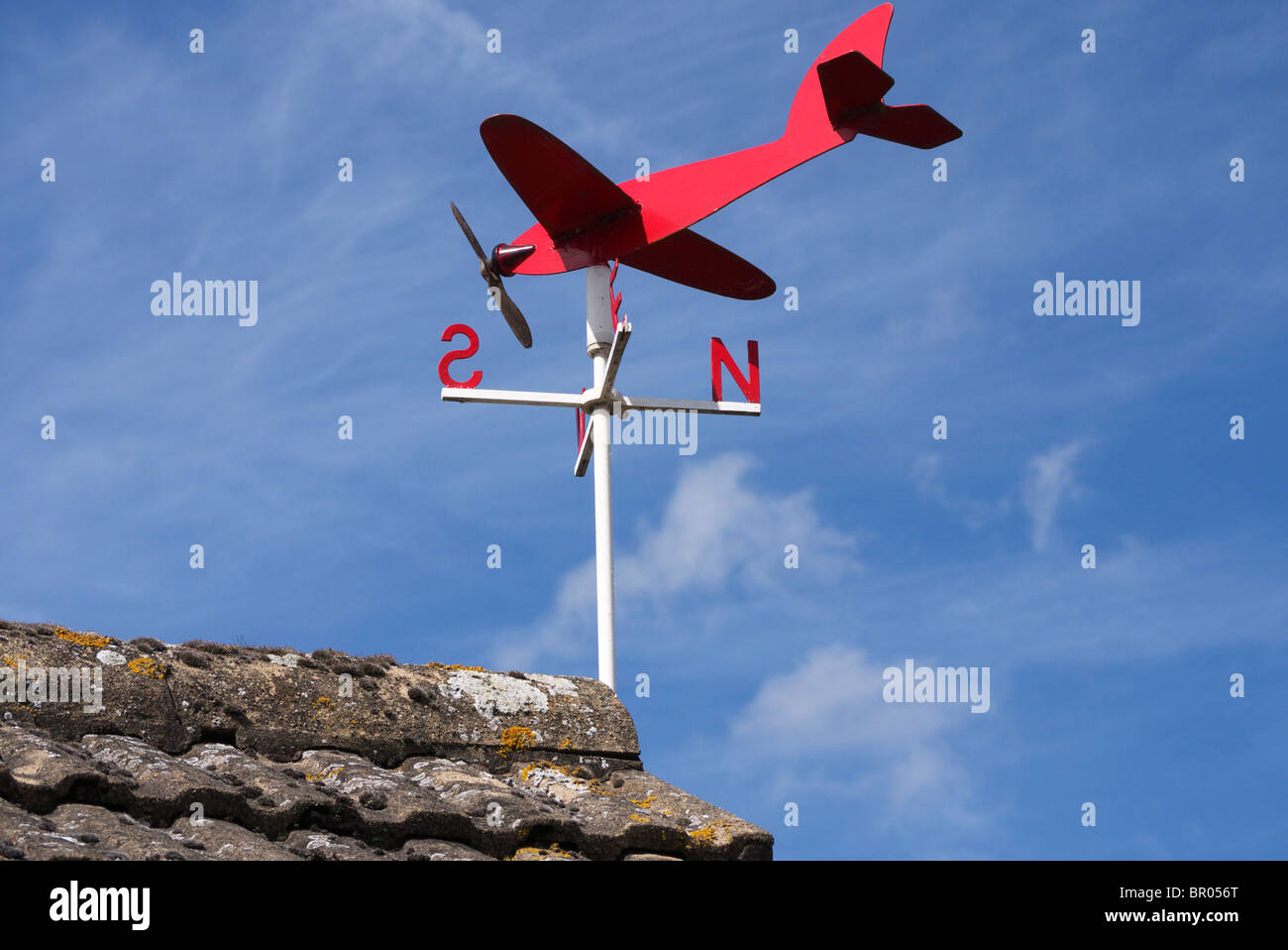 Weather vain in the shape of a plane indicating the the direction of ...