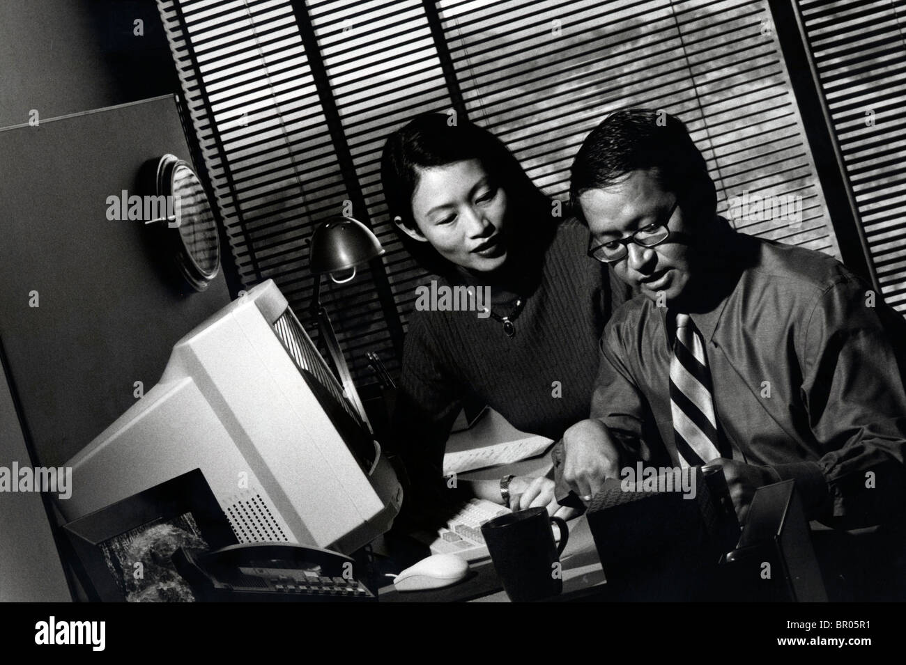 Two computer engineers work on a future developmental project for a ...