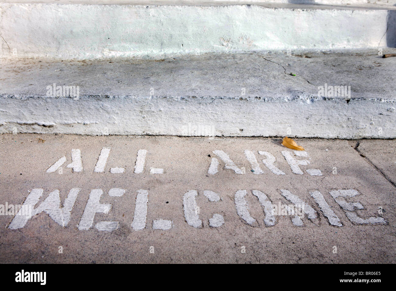 All Are Welcome sign painted on the concrete Stock Photo - Alamy