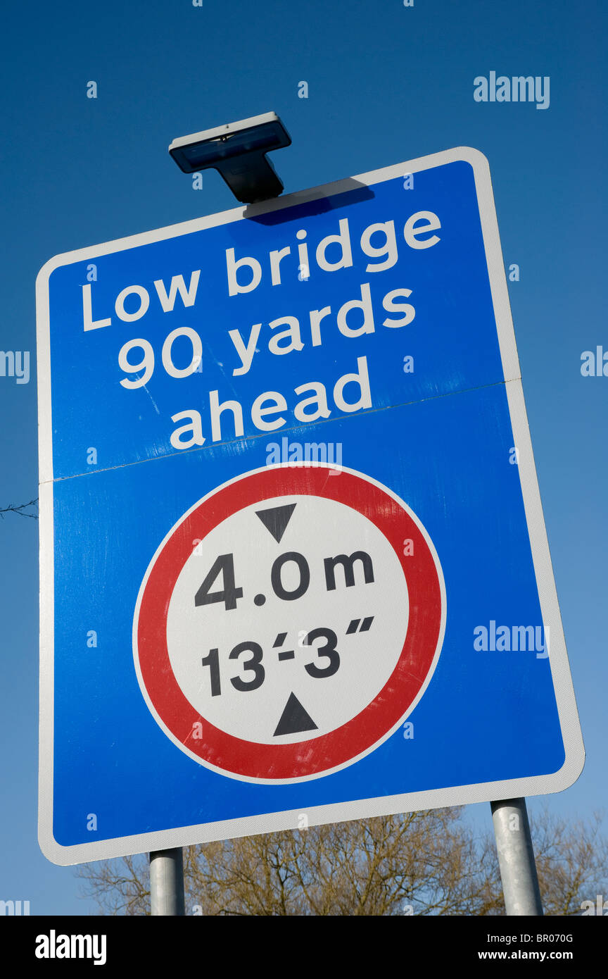 Road sign warning of a low bridge in a market town in England Stock ...