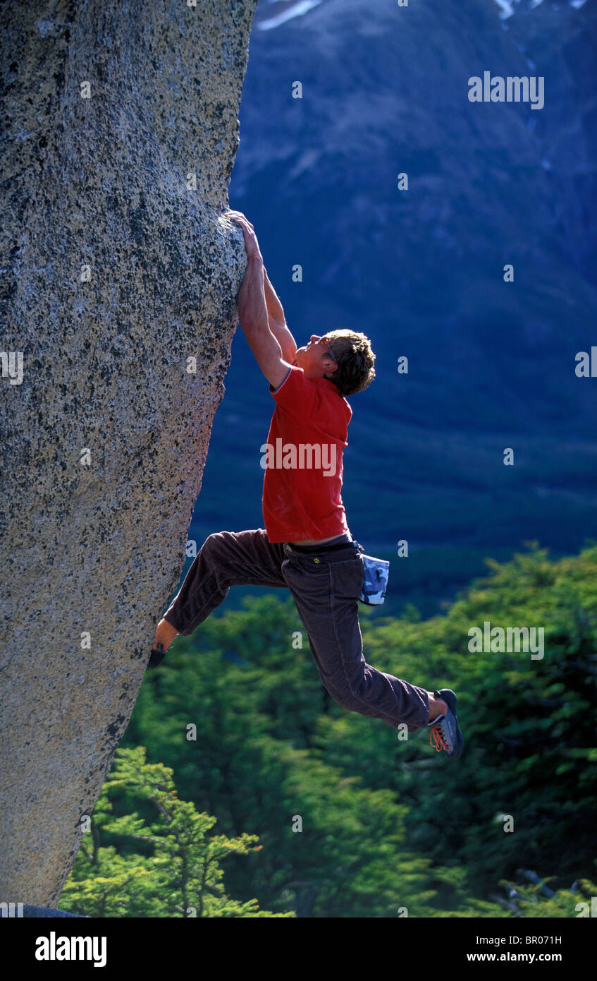 A male athlete hanging on to a bouldering route Stock Photo - Alamy