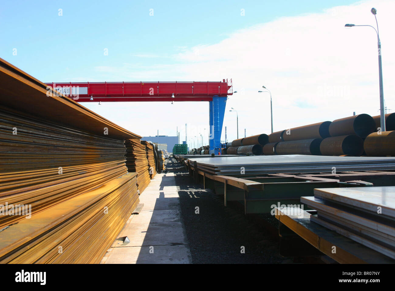 Big diameter ferrous metal pipes and steel sheets loading on the ...