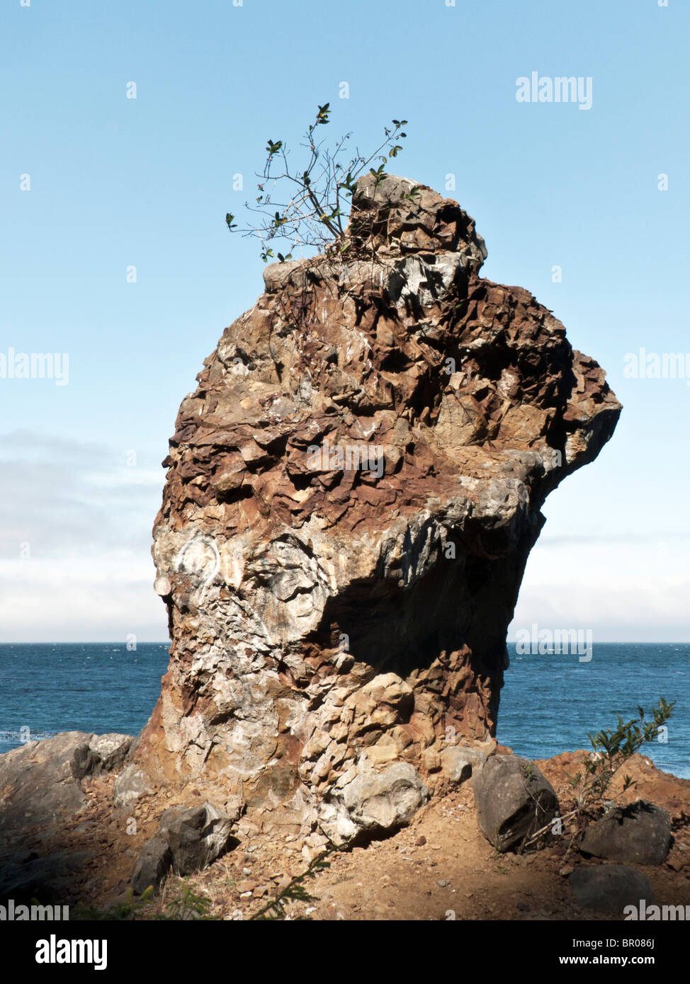 sunlit sea stack against clear blue sky on north coast of Olympic ...