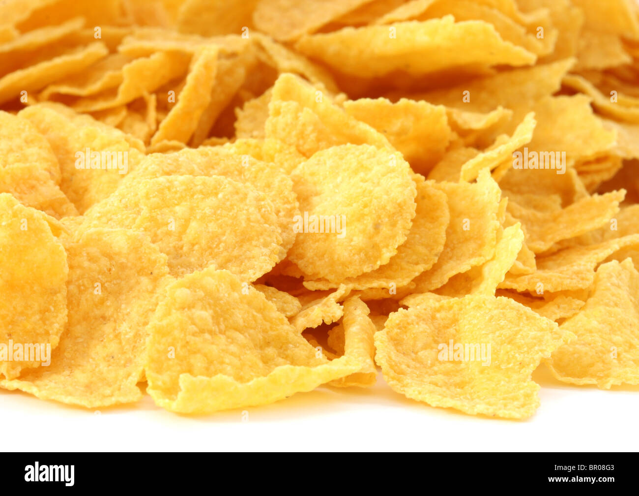 Corn flakes scattered on white background Stock Photo - Alamy