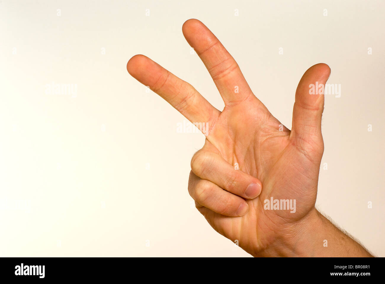 Male hand showing three fingers Stock Photo - Alamy