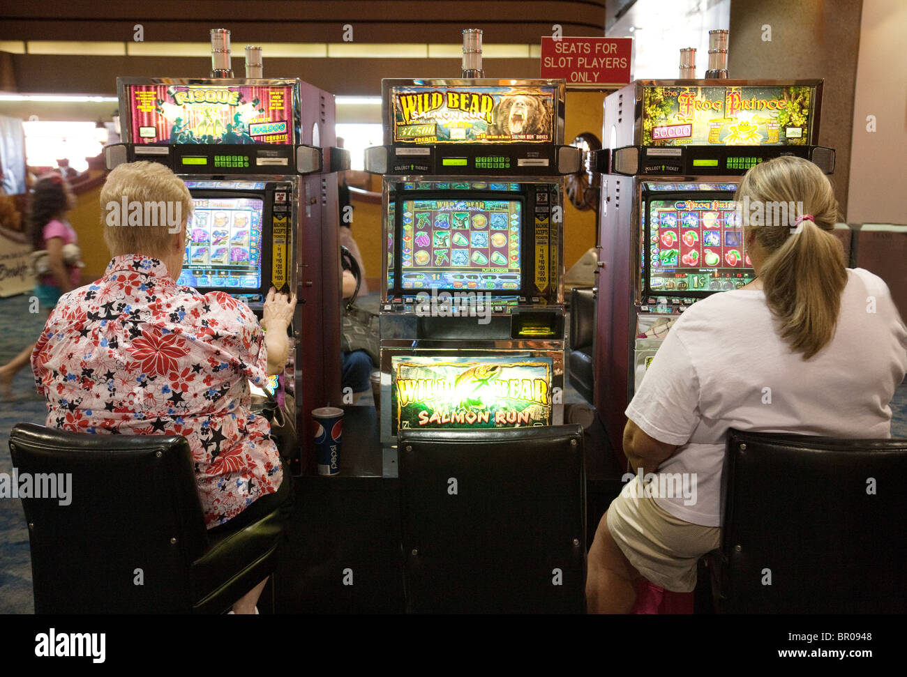Two women playing the slot machines at Las Vegas airport, Las Vegas ...