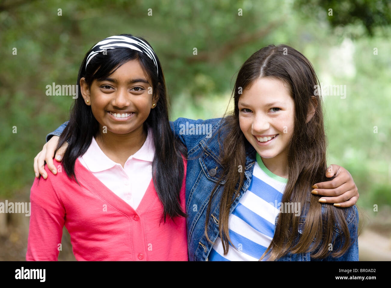Smiling girls hugging outdoors Stock Photo - Alamy