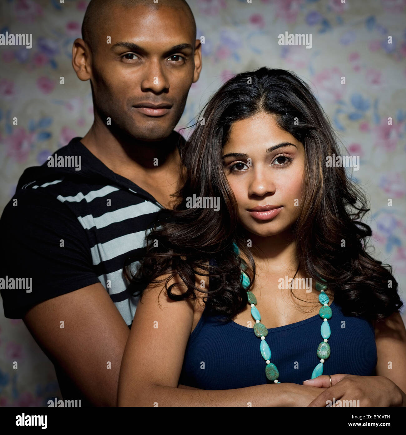 Hispanic couple hugging Stock Photo - Alamy