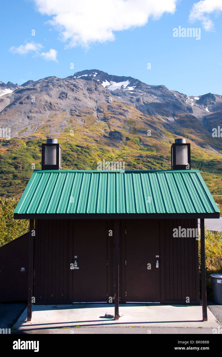 Public outhouse with chimney's frame mountains in background Stock ...