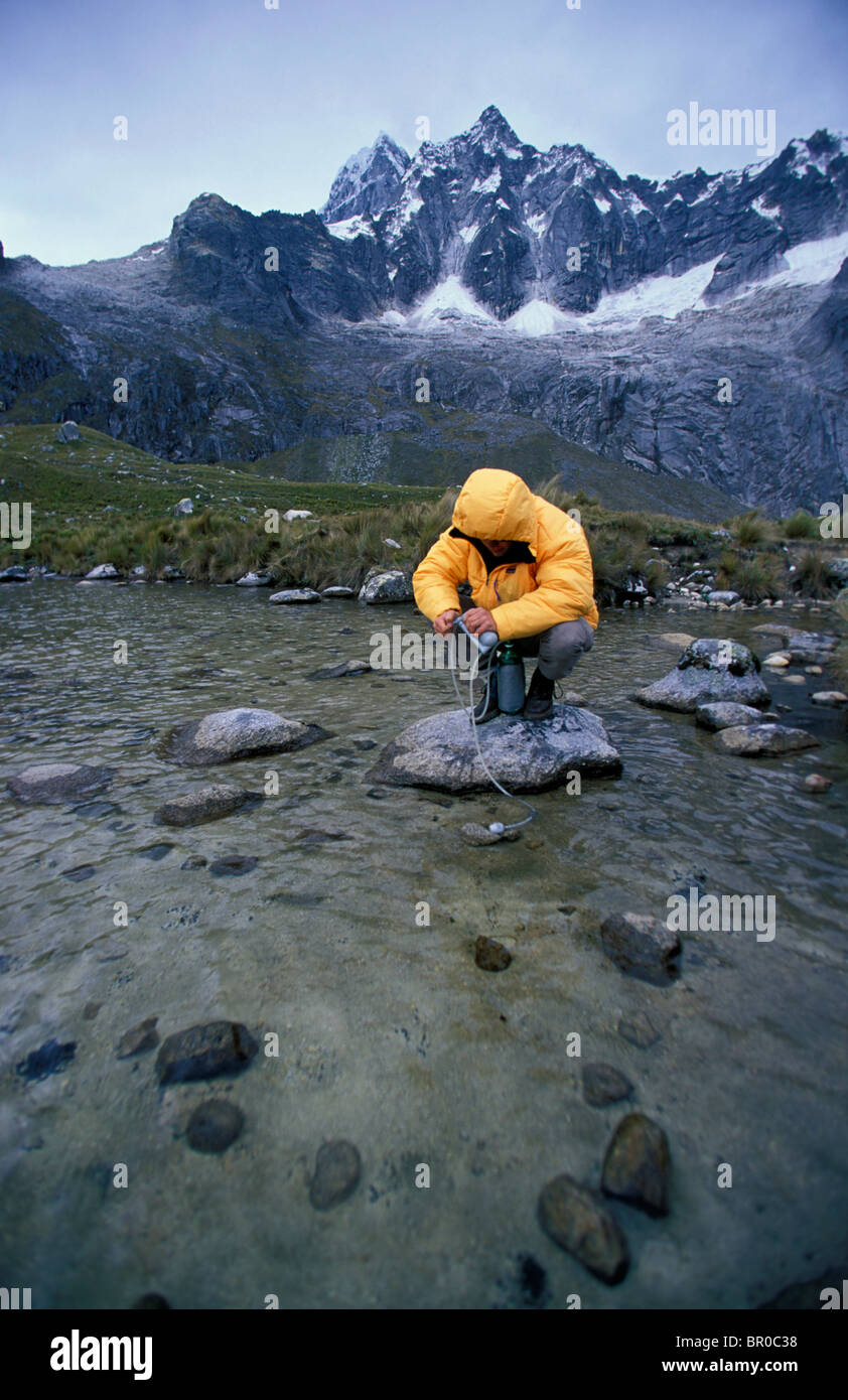 A man filters water from a mountain stream Stock Photo - Alamy