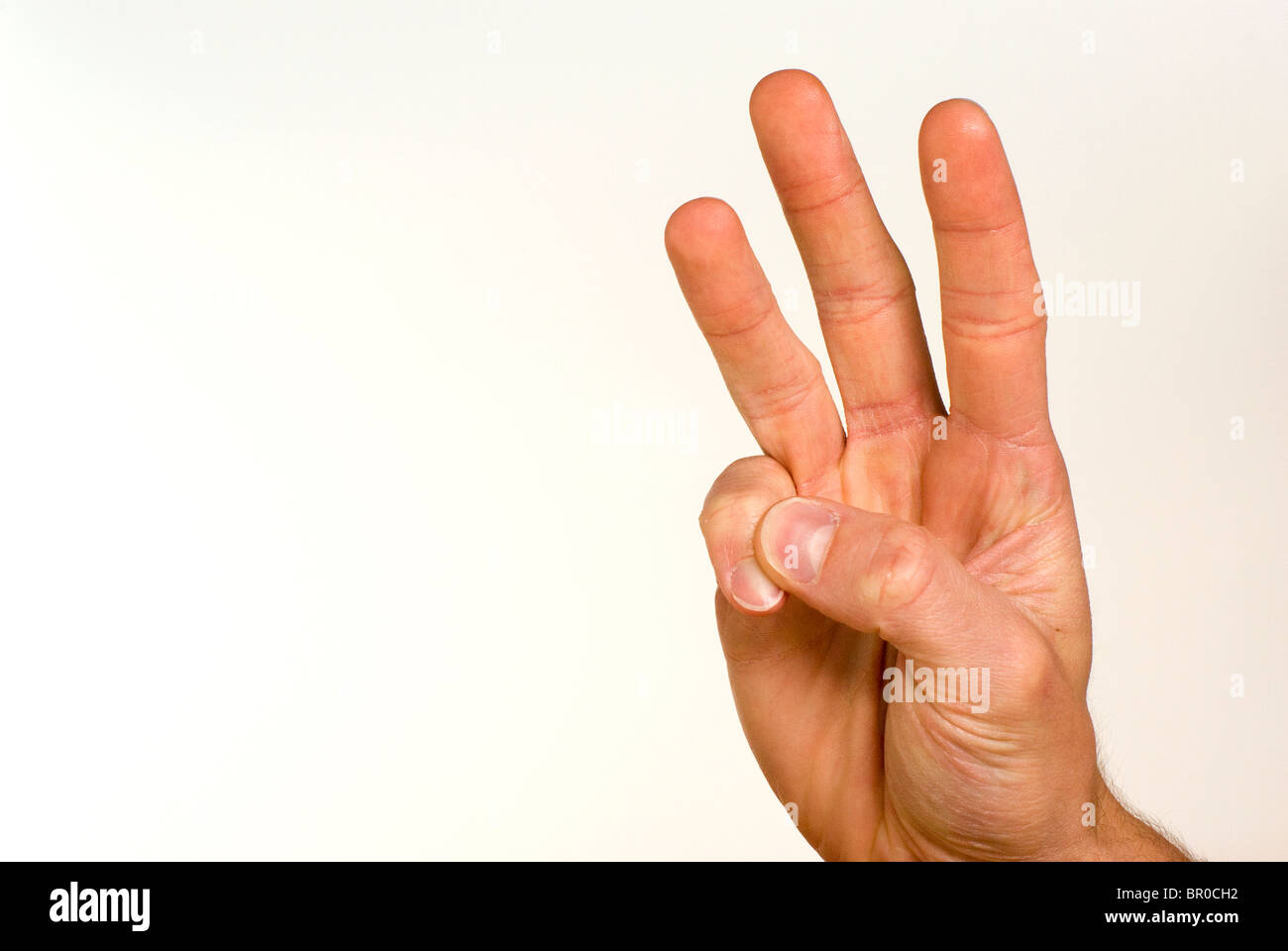 Male hand showing three fingers Stock Photo - Alamy
