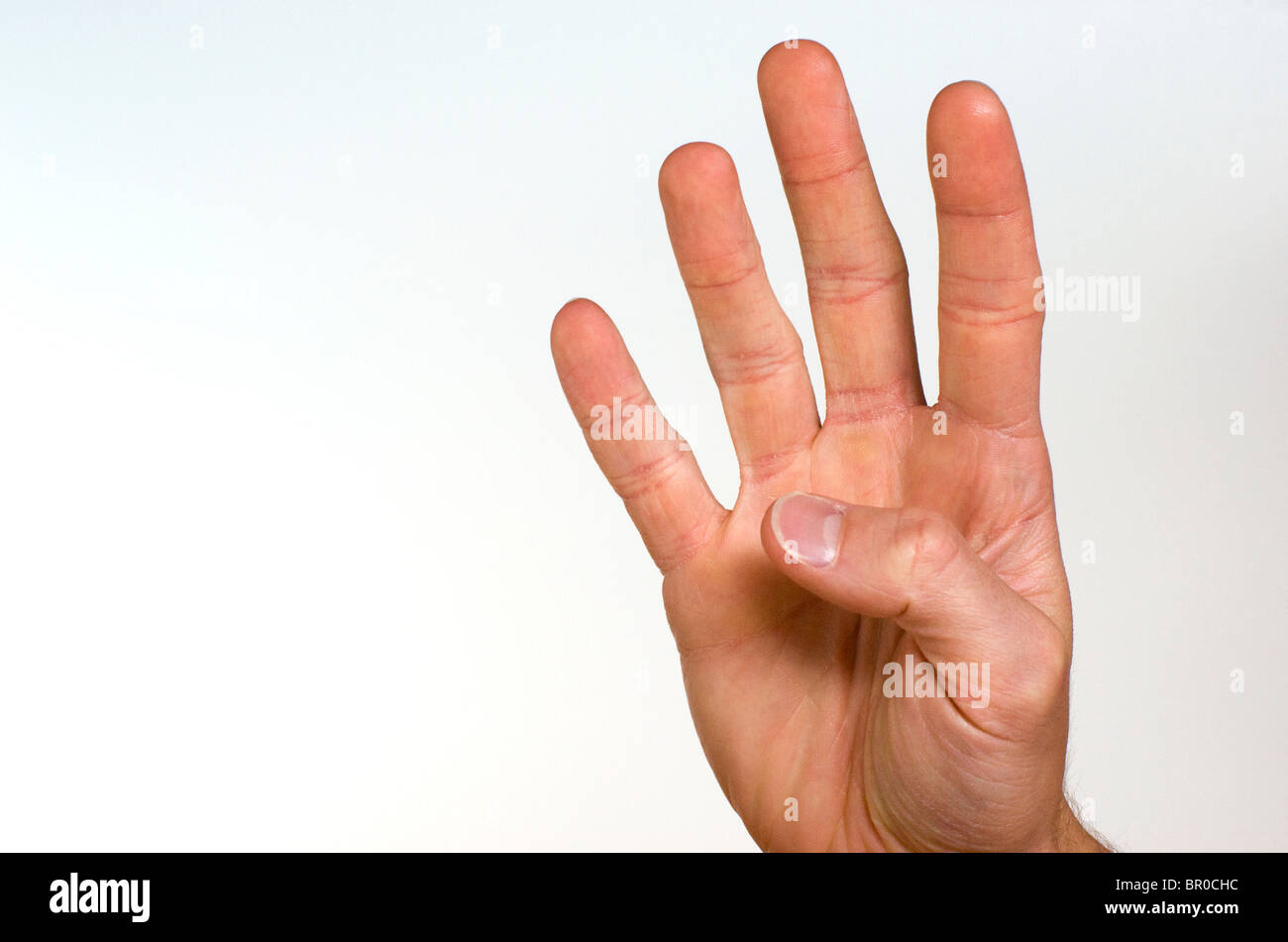 Male hand showing four fingers Stock Photo - Alamy
