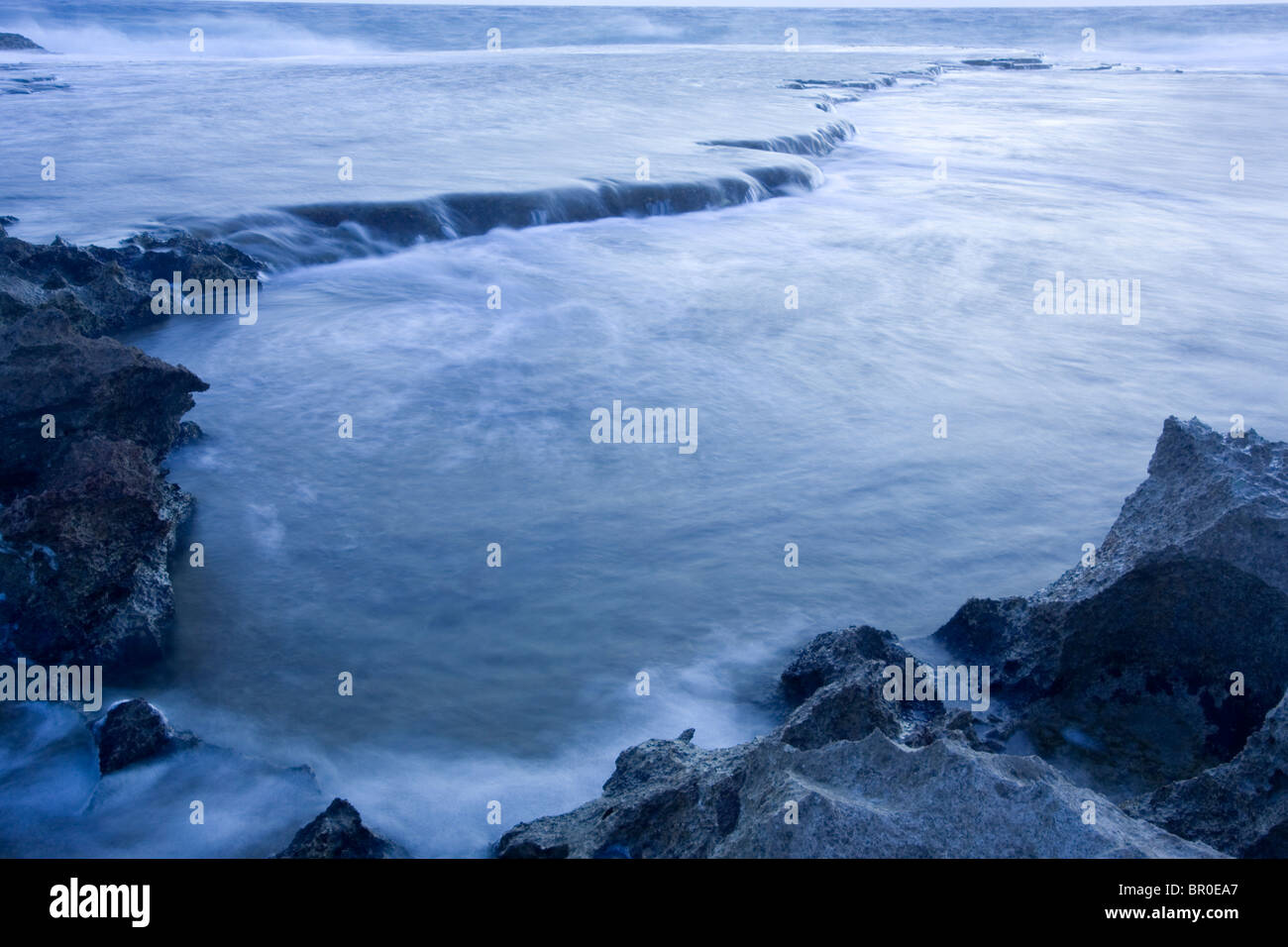 A tidal pool created by volcanic rock at Moomomi beach on the Pacific ...