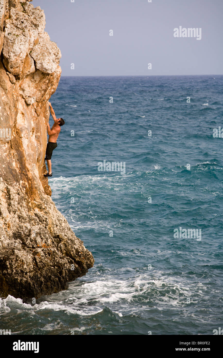 A man rock climbing / deep water soloing Stock Photo - Alamy