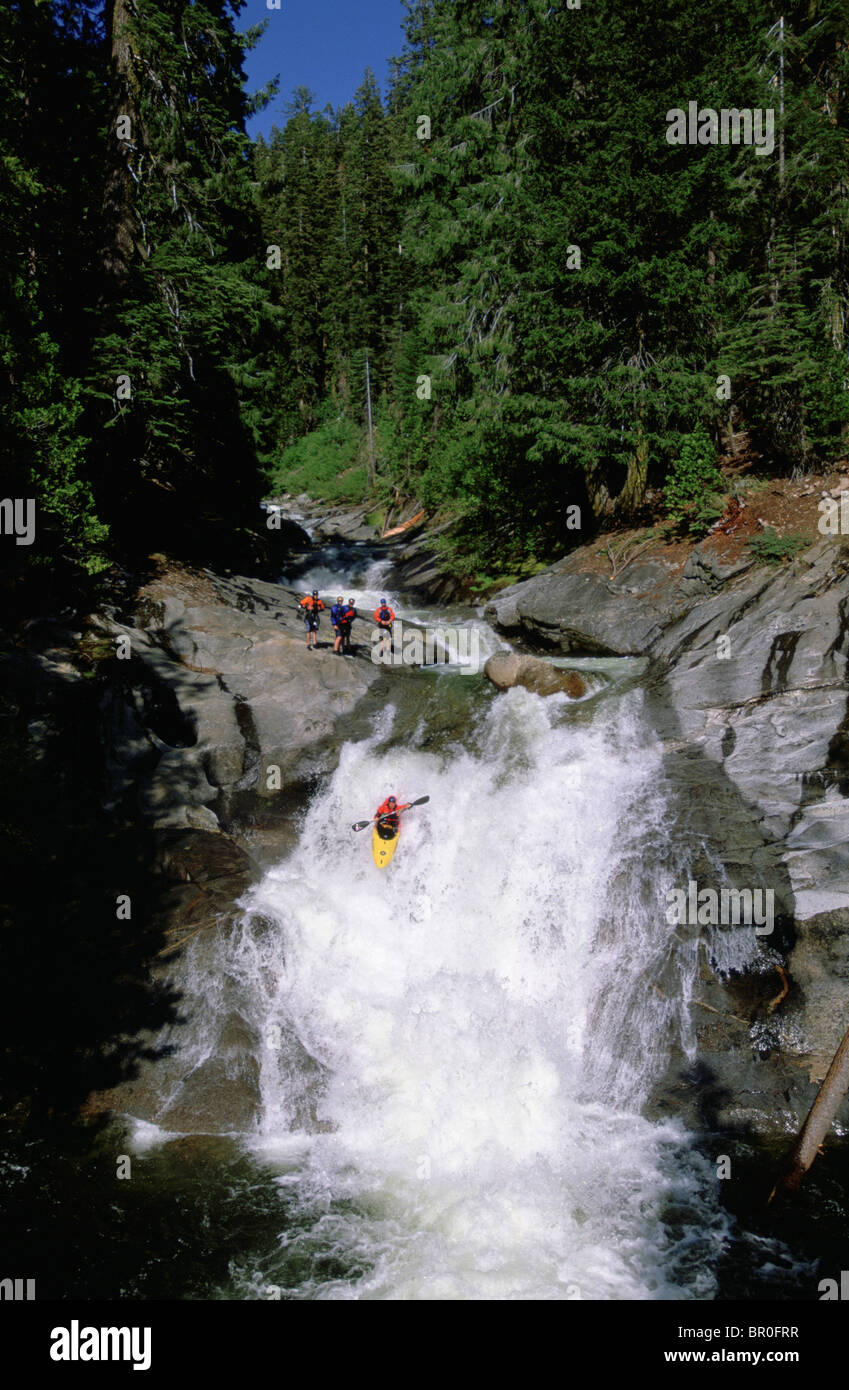 A kayaker runs a steep waterfall on the American River in the Sierra ...