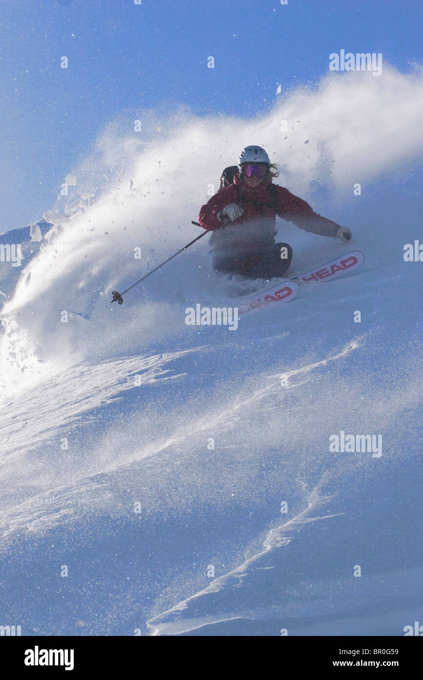 A woman skiing powder snow on a windy day on Donner Summit in ...