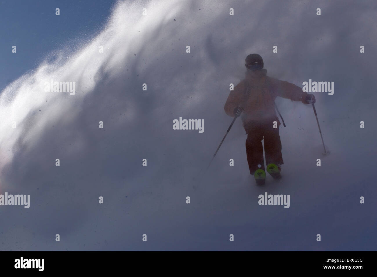 A man skiing powder snow on a windy day on Donner Summit in California ...