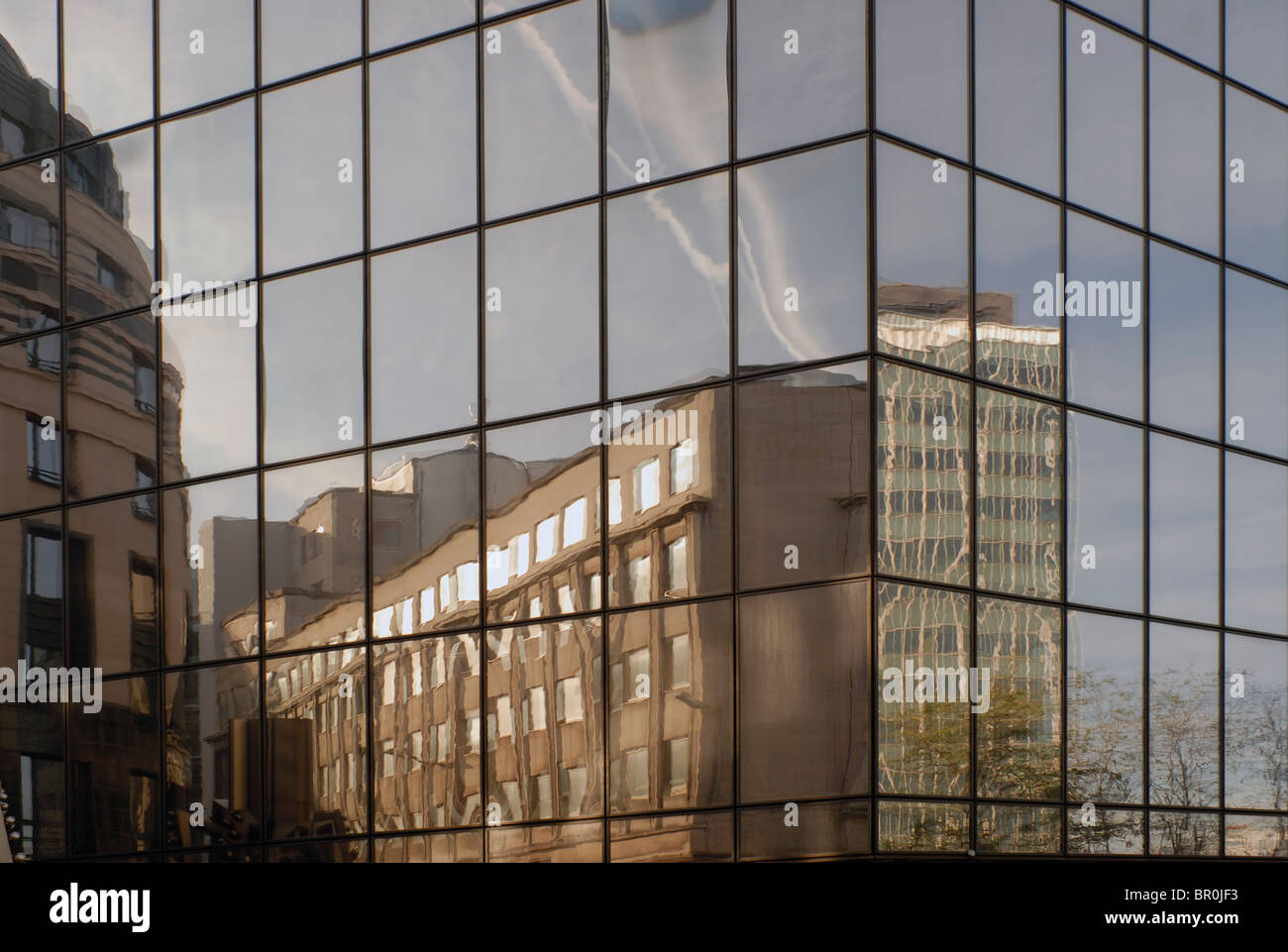 office buildings reflected in the windows of the modern office building ...