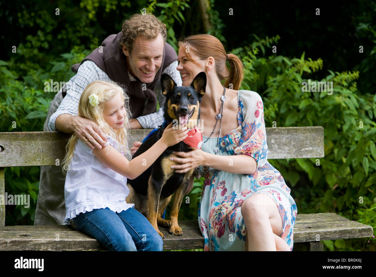 family with their pet dog Stock Photo - Alamy