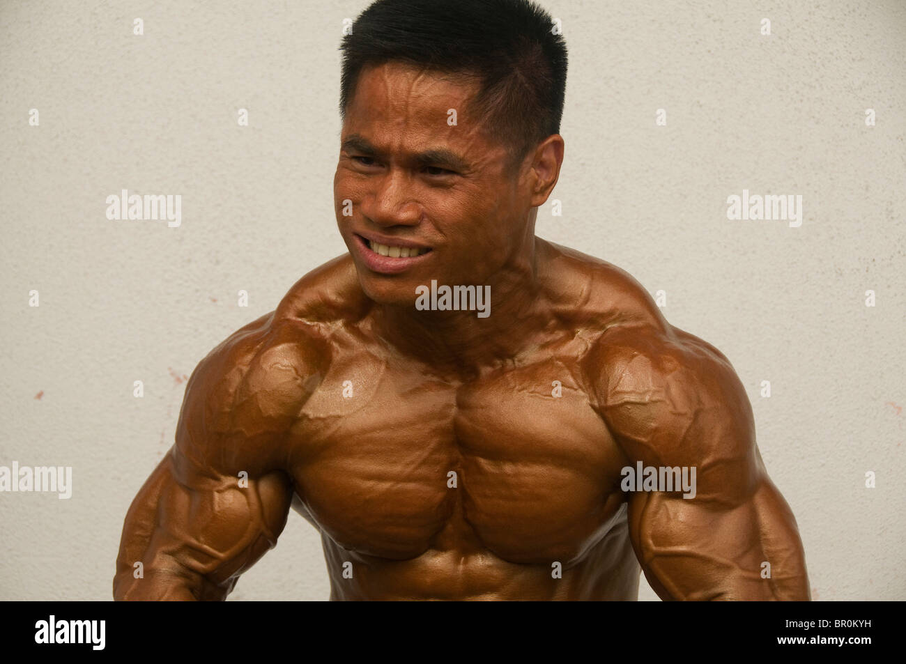 bodybuilder shows his muscles at a competition in Bangkok Thailand ...