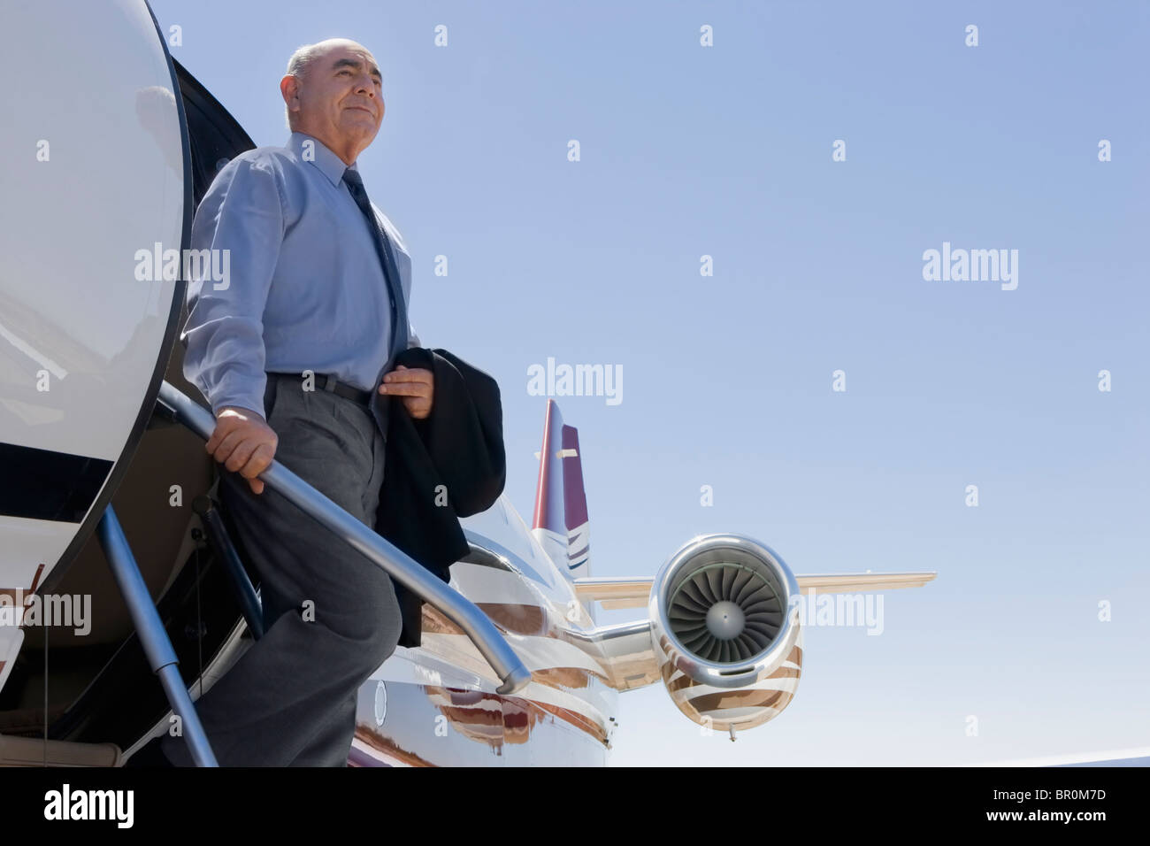 Hispanic businessman exiting private jet Stock Photo - Alamy