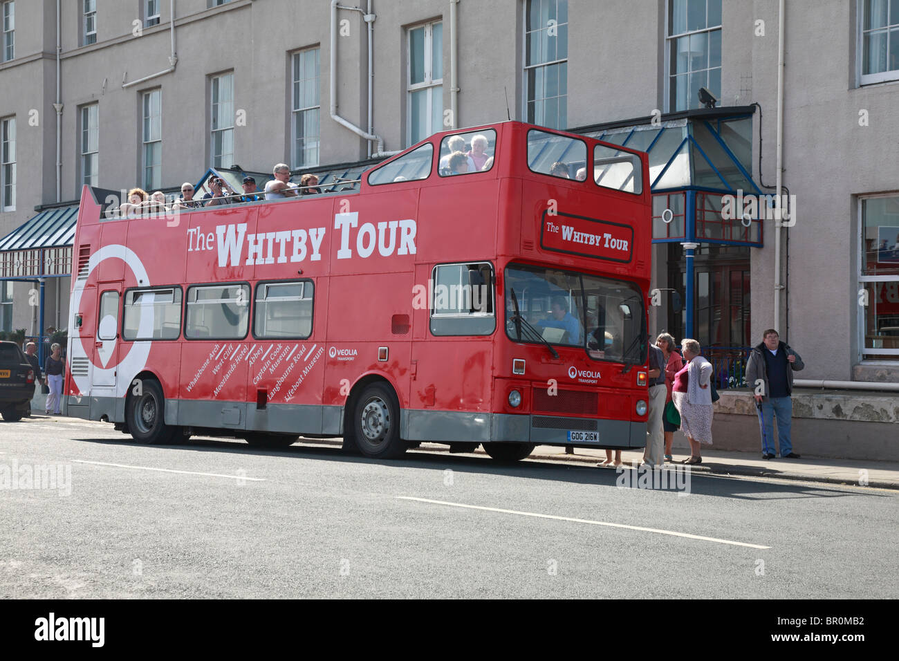 The Whitby Tour red open top tour bus collecting passengers in Whitby ...