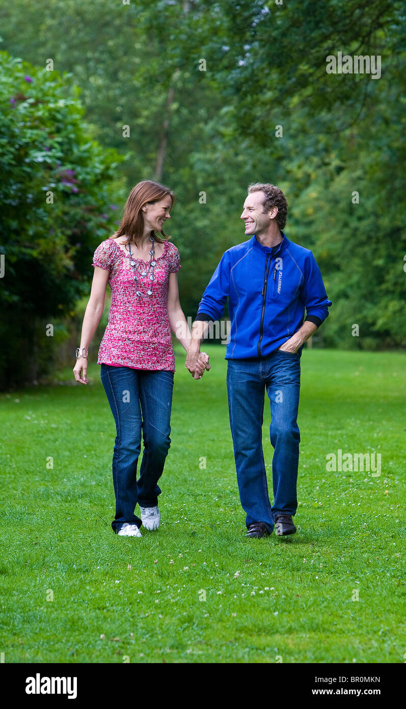 Couple walking together in a rural setting Stock Photo - Alamy