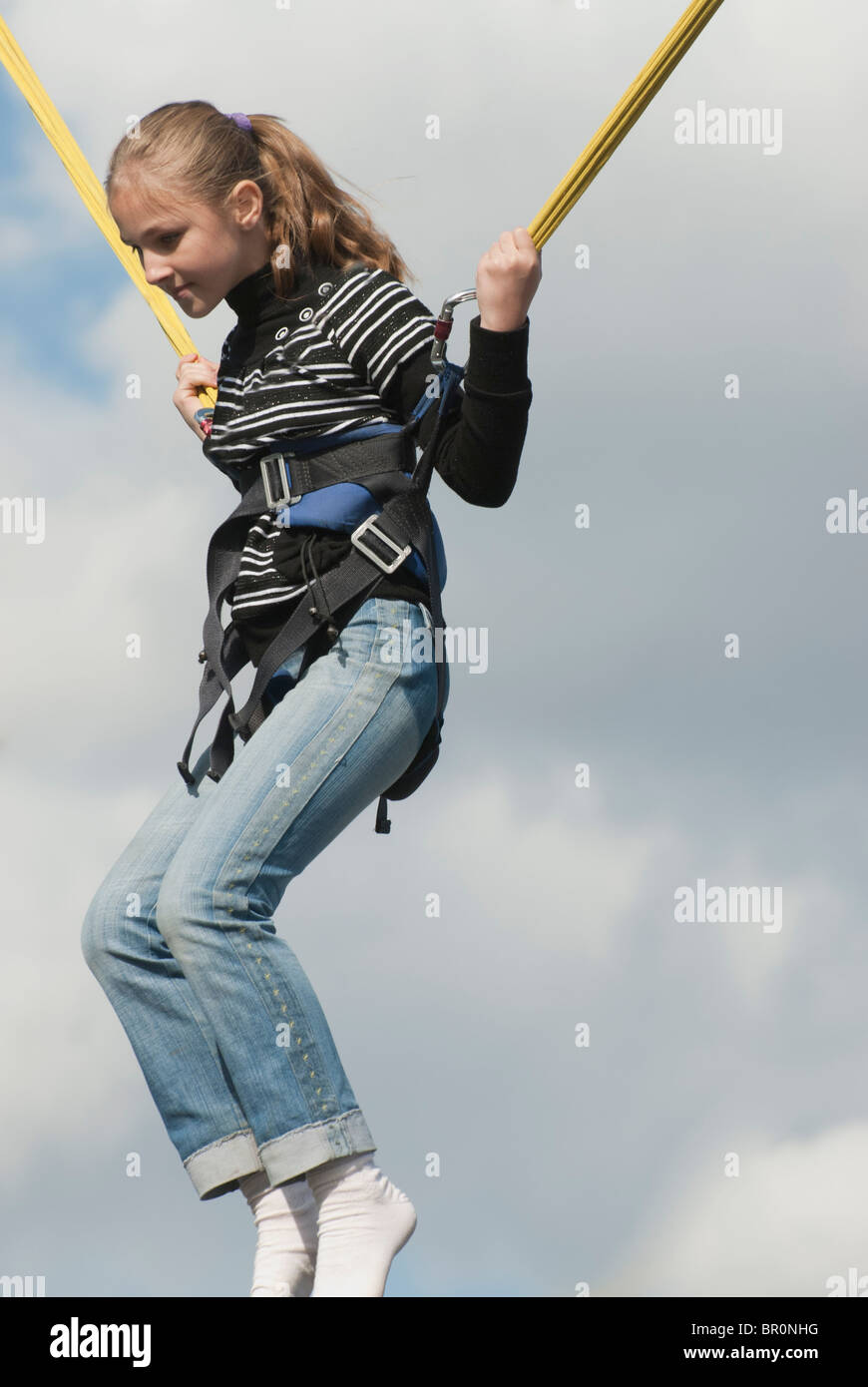 Jumping girl on the power jump ride Stock Photo - Alamy