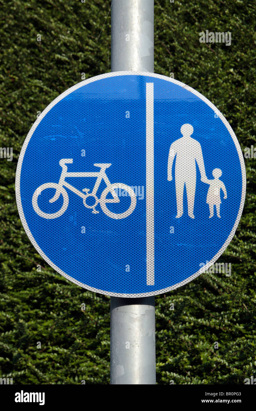 A blue sign showing a shared pedestrian and bicycle footpath close to ...