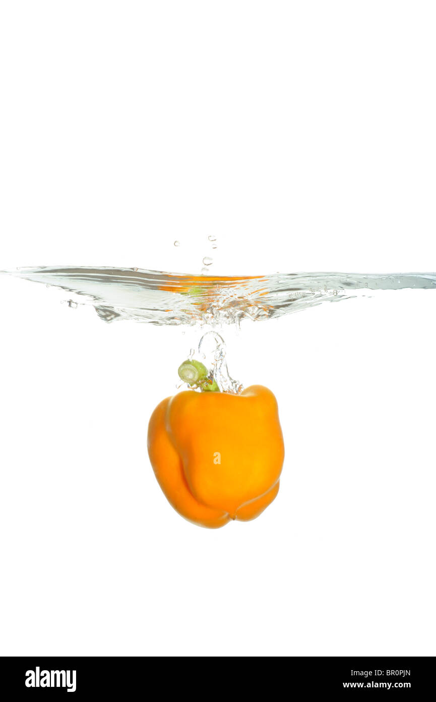 an orange pepper splashing into clear water Stock Photo - Alamy