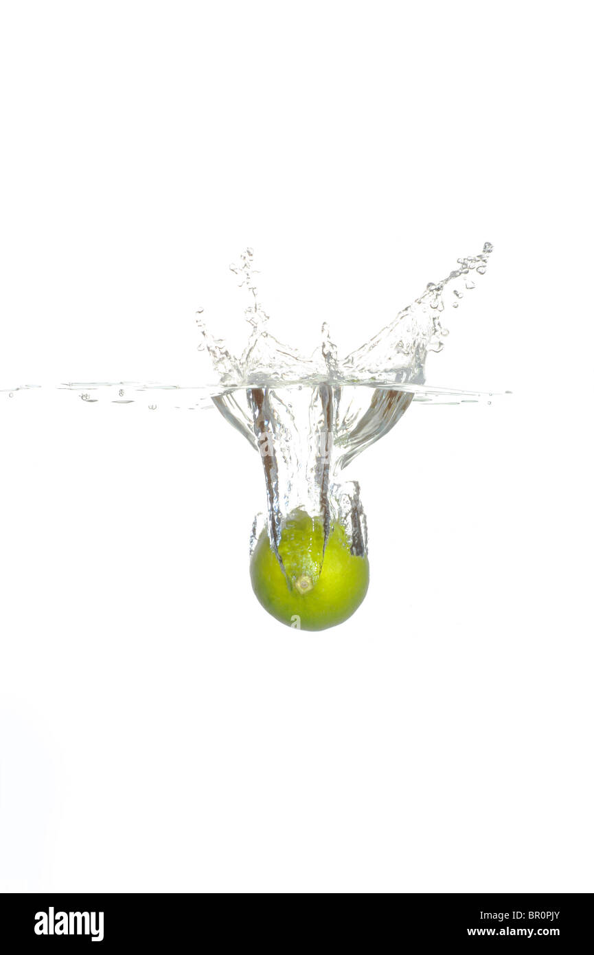 a fresh bright green lime splashing into clear water Stock Photo - Alamy