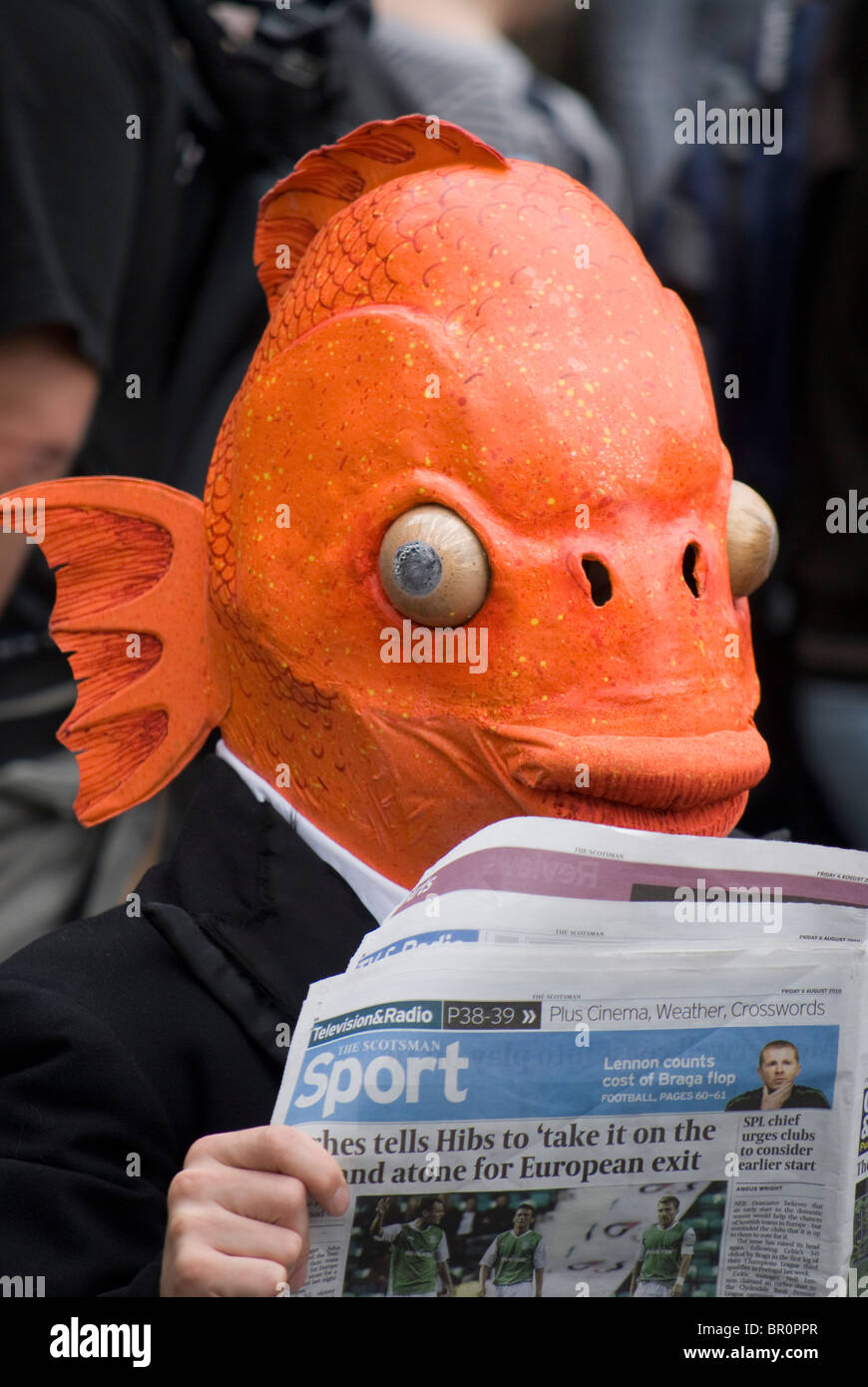 Man with goldfish head reading a newspaper, promoting a Fringe show in ...