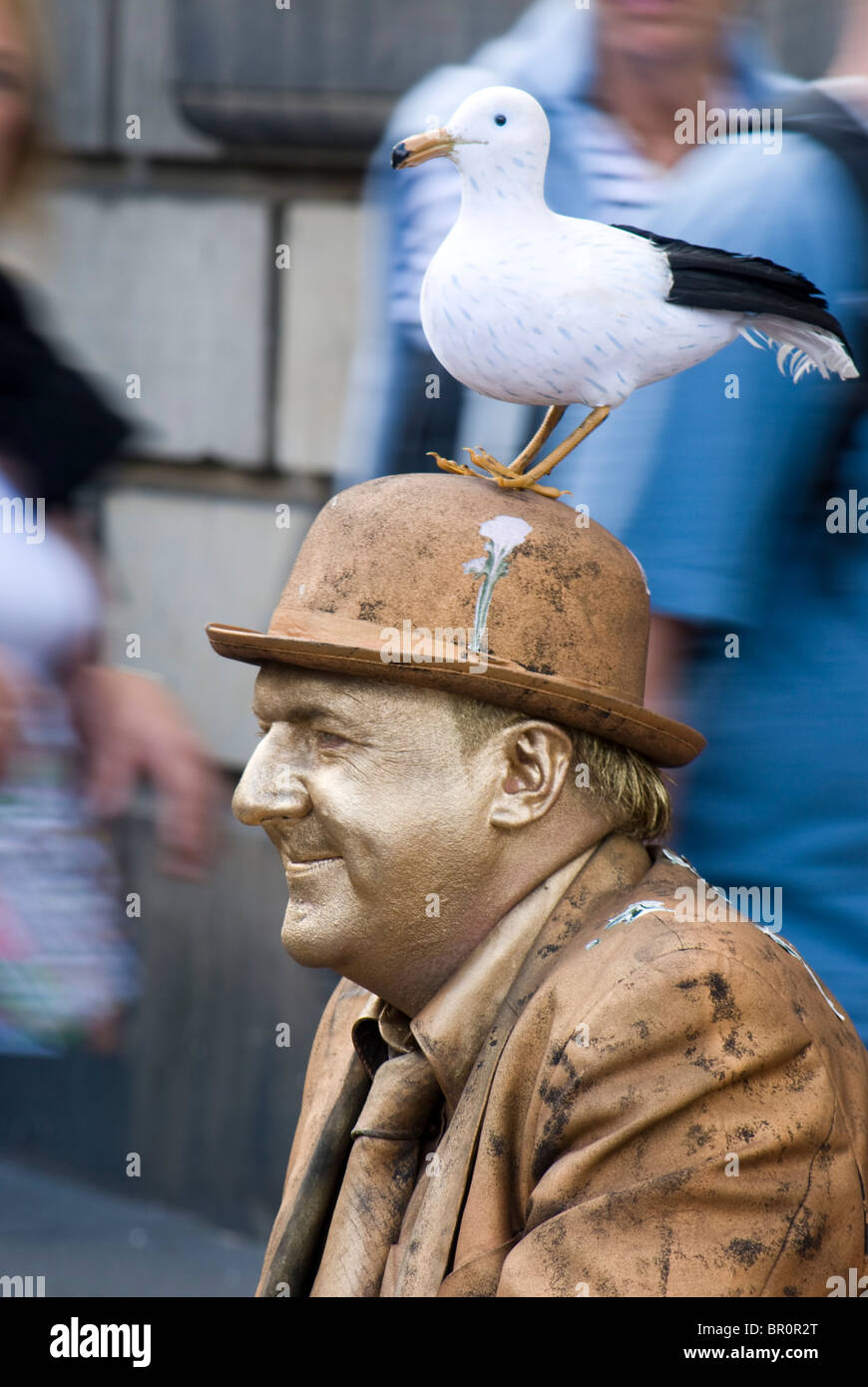 Human statue man with a seagull sitting on his hat during the Edinburgh ...