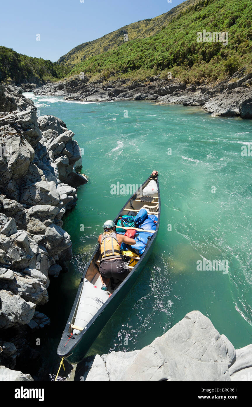 New Zealand, South Island, Hurunui River. Heather Hamilton securing ...