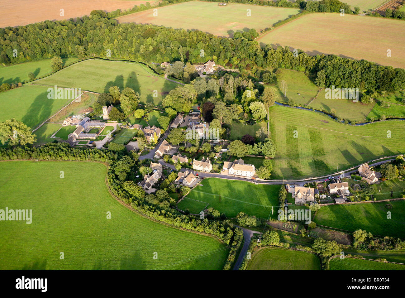 An aerial view of the Cotswold village of Coln Rogers, Gloucestershire ...