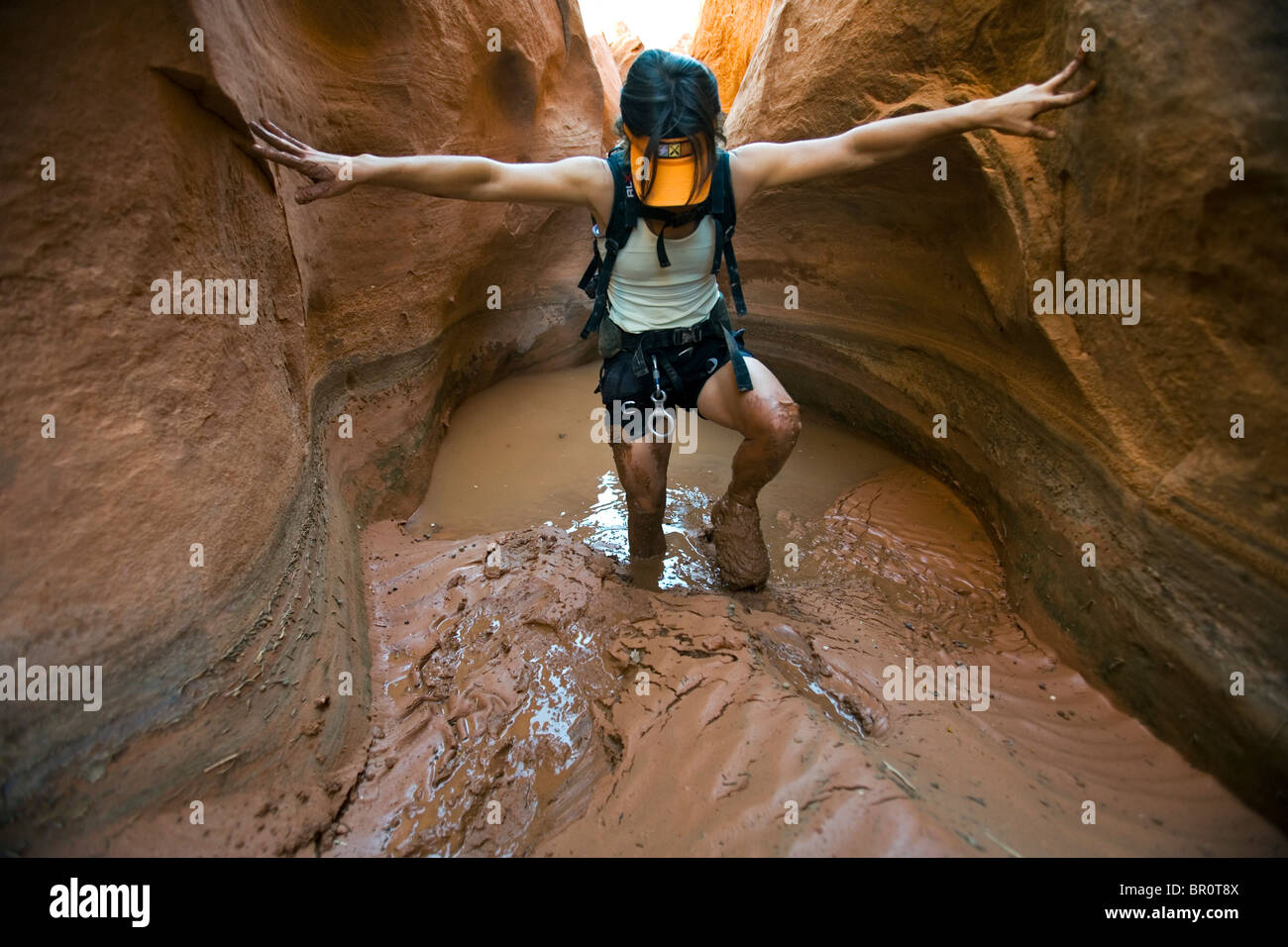A woman hiking through mud in canyon, Utah Stock Photo - Alamy