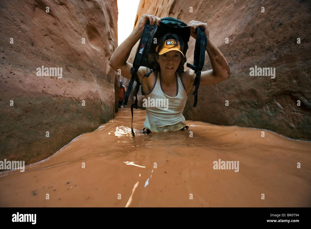 A woman wading through water in narrow canyon, Utah Stock Photo - Alamy