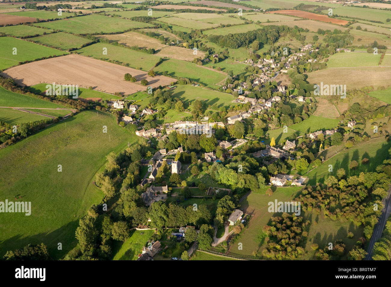 An aerial view of the Cotswold village of Naunton, Gloucestershire from ...