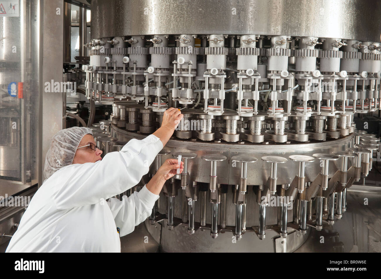 Quality control woman collecting wine sample in Adega Cooperativa de ...